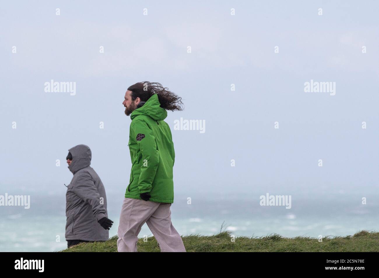 People walking into strong winds brought by Storm Jorge at Newquay in ...