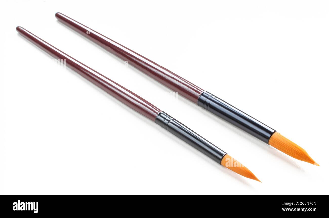 Two paint brushes of different size isolated on white background. Clean ...