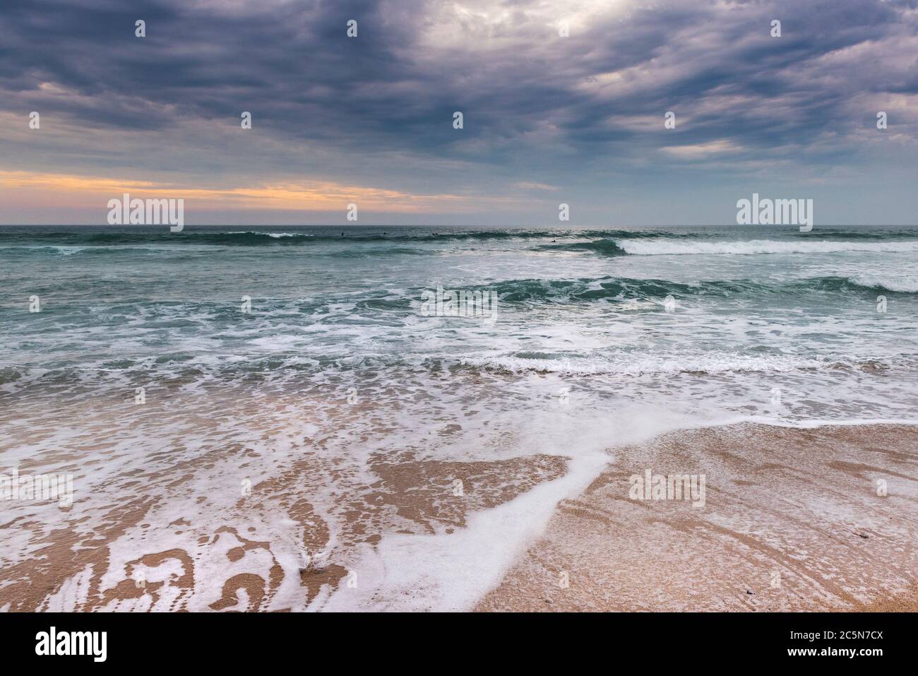Evening light over the incoming tide at Fistral Beach in Newquay in ...