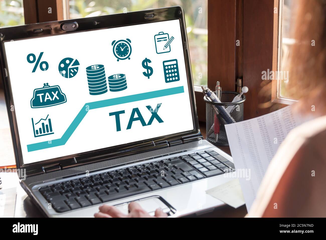 Laptop screen showing tax concept Stock Photo - Alamy