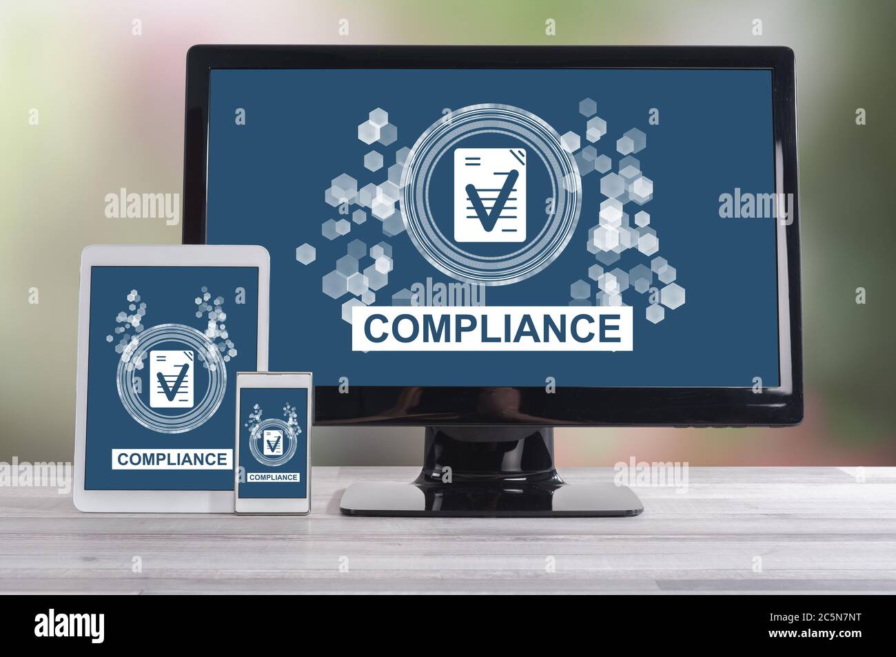 Compliance concept shown on different information technology devices ...