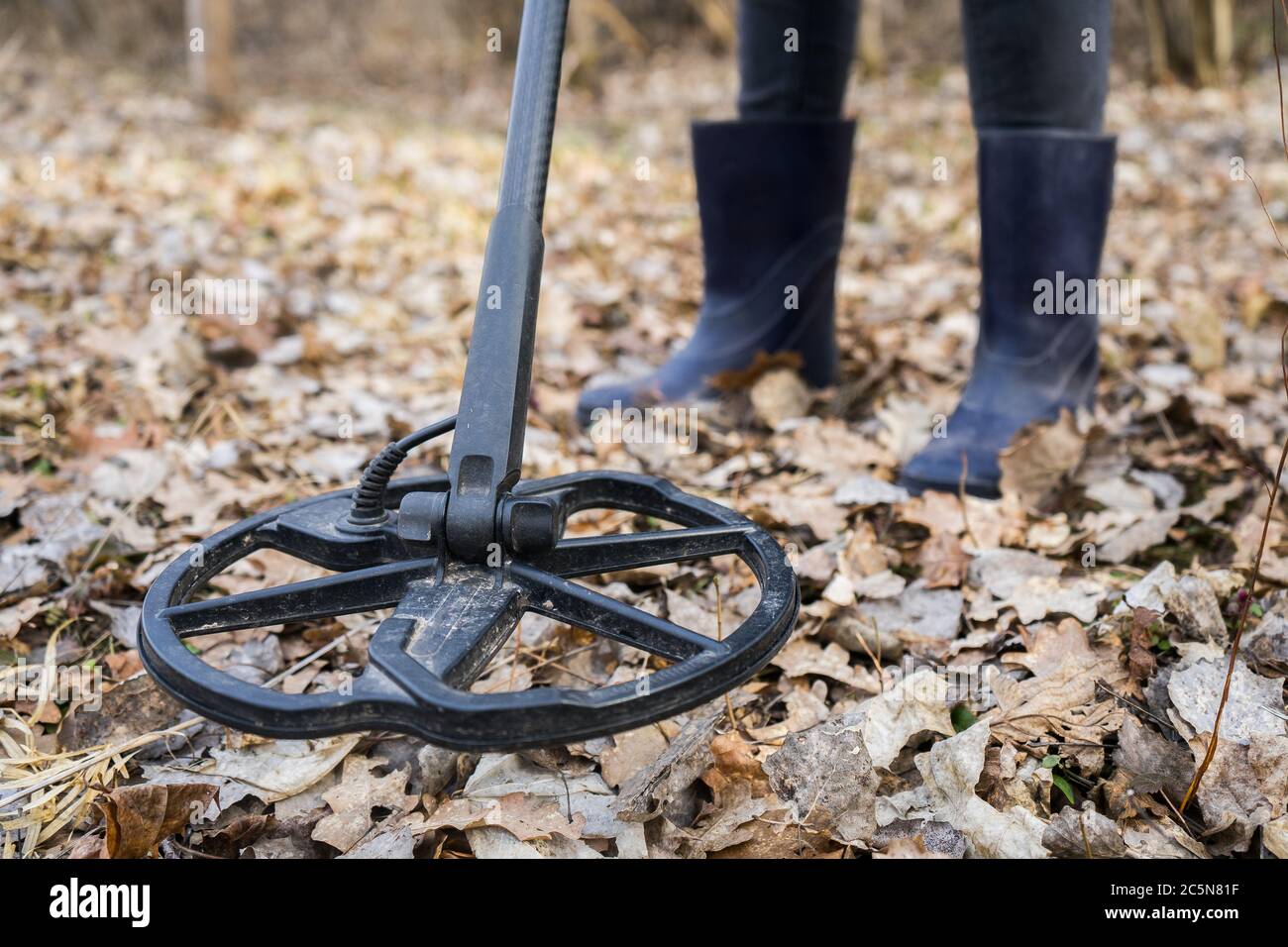 girl archaeologist or metal digger is looking for coins or metal Stock ...