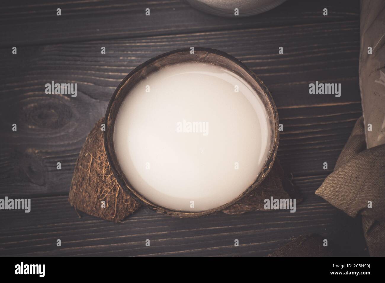 Coconut milk on a wooden background. Coconut and coconut milk. Fresh ...
