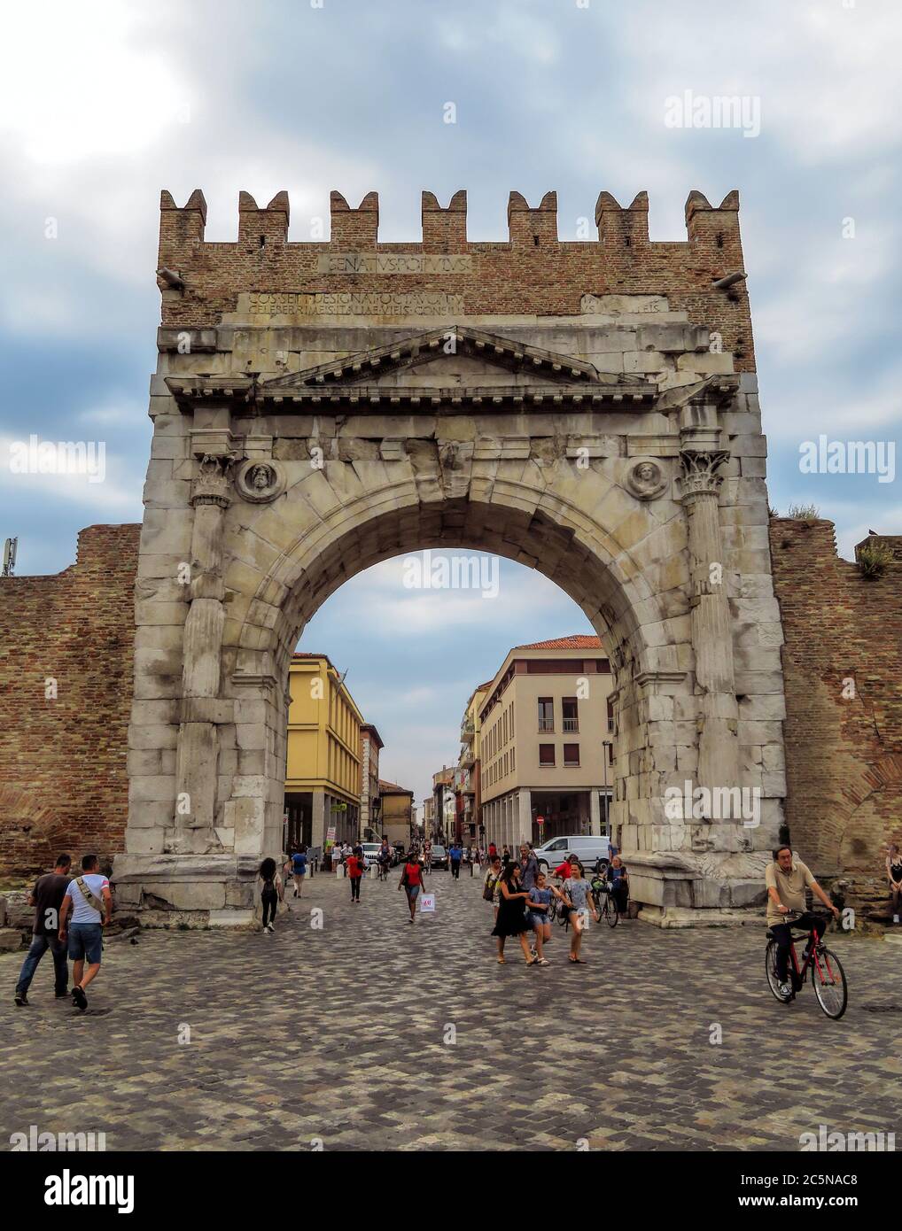 Rimini, Italy - June 14, 2017: Unidentified people walk under Augustus ...