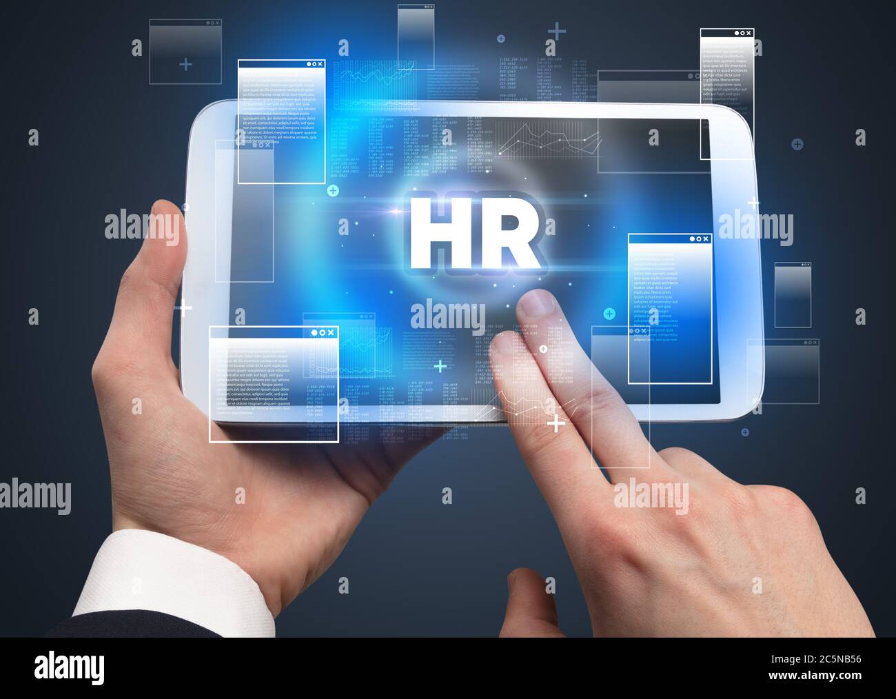 Close-up of a hand holding tablet with HR abbreviation, modern ...