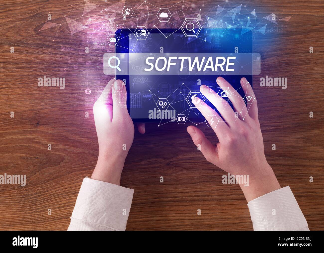 Close-up of a tablet searching SOFTWARE inscription, hi-tech computing ...