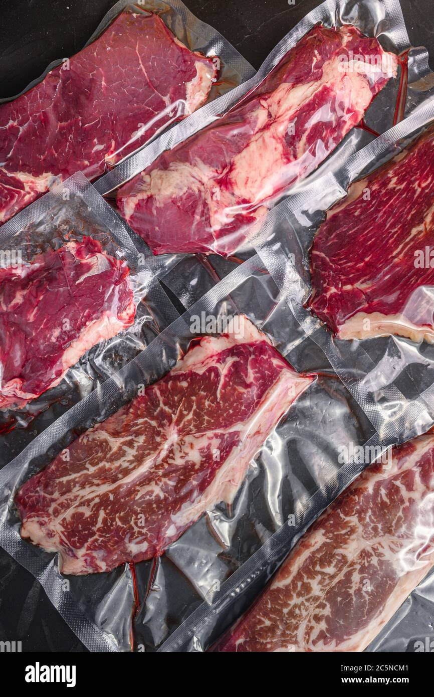 Set of vacuum packed organic raw beef alternative cuts: top blade, rump ...