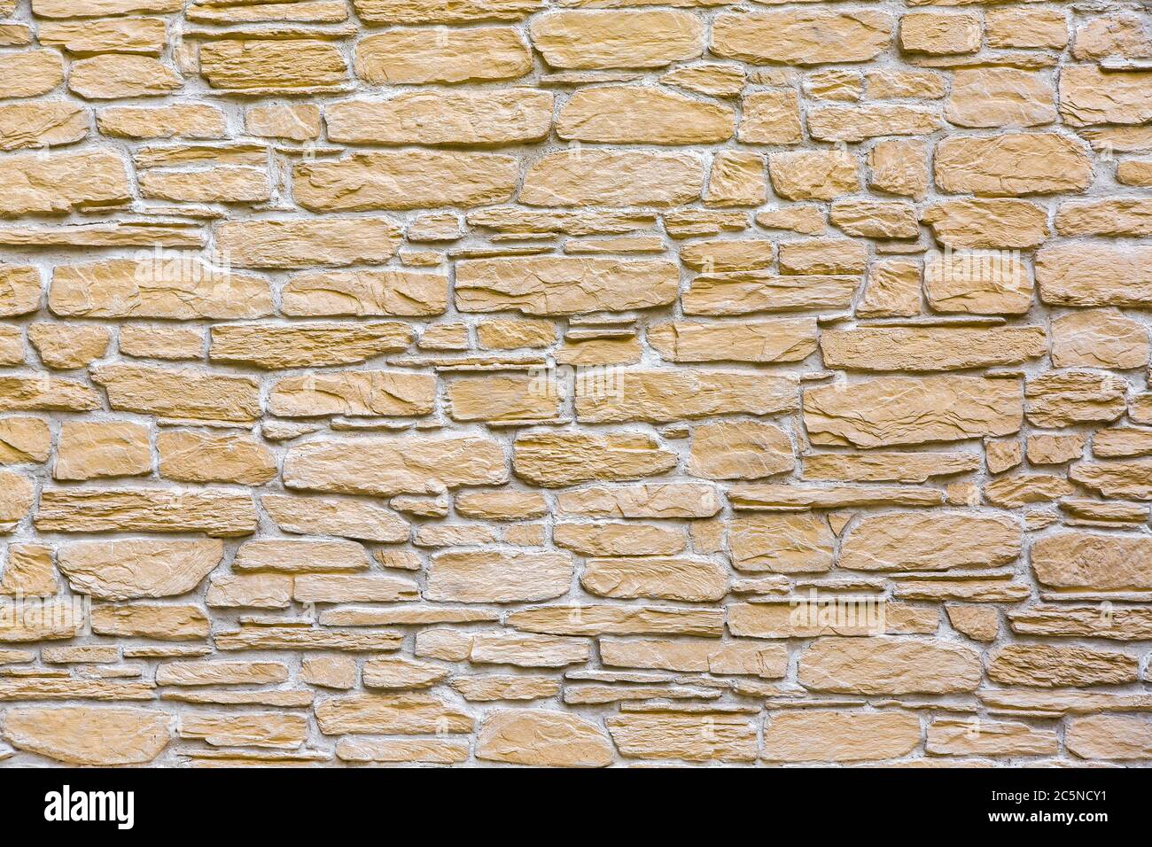decorative masonry of natural stone of different sizes, wall texture of ...