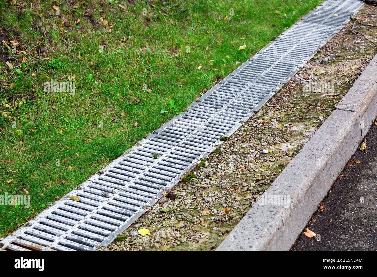 drainage system on the side of the road behind a gutter with an iron ...