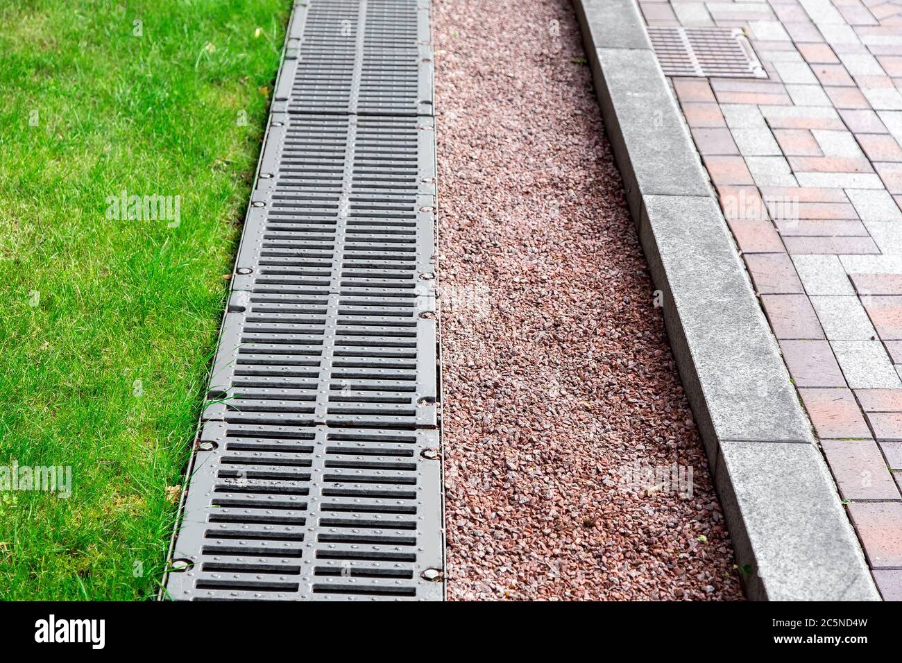 drainage system in the park, drainage grate and pebbles close up detail ...