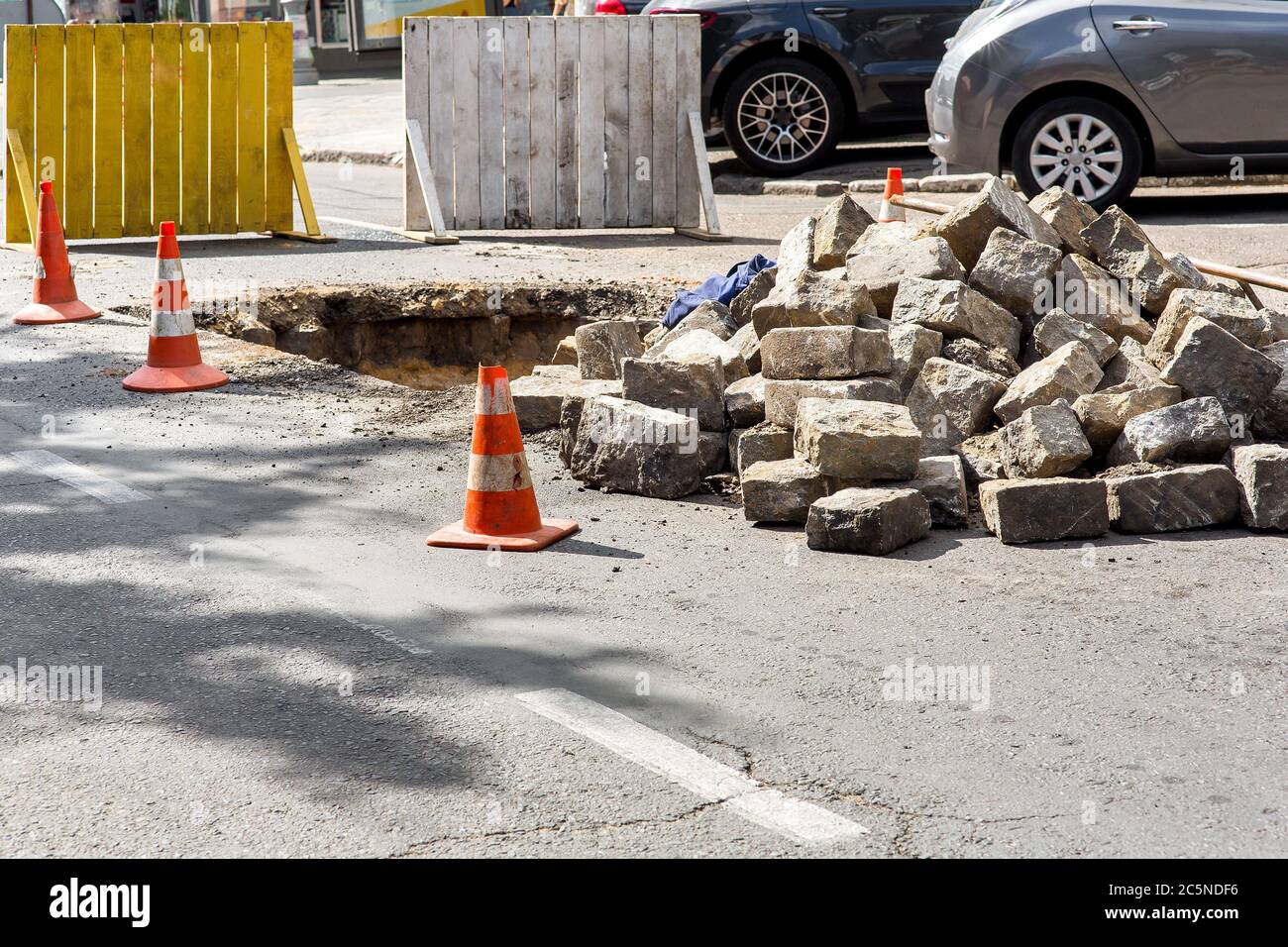 The road repair work and caution with blocked barrier protecting road ...