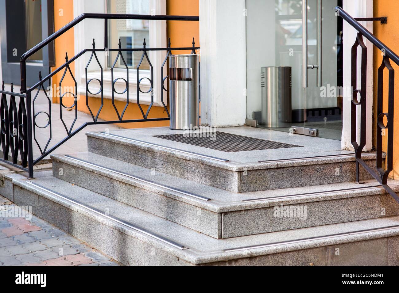 entrance to the store with stone steps and a glass door, at the ...