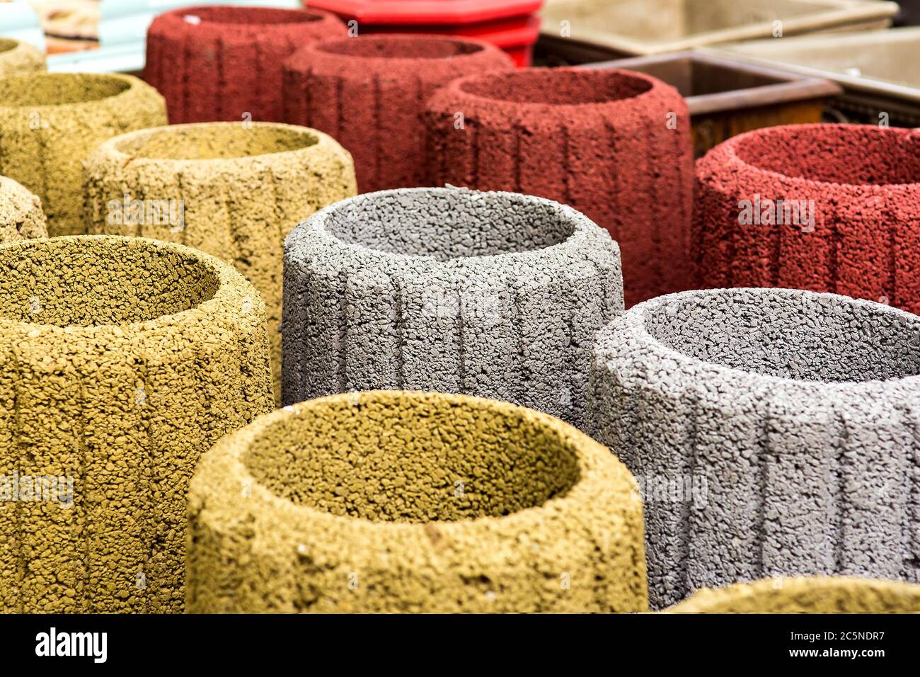 stone trash can in an assortment of new multi-colored garbage cans ...