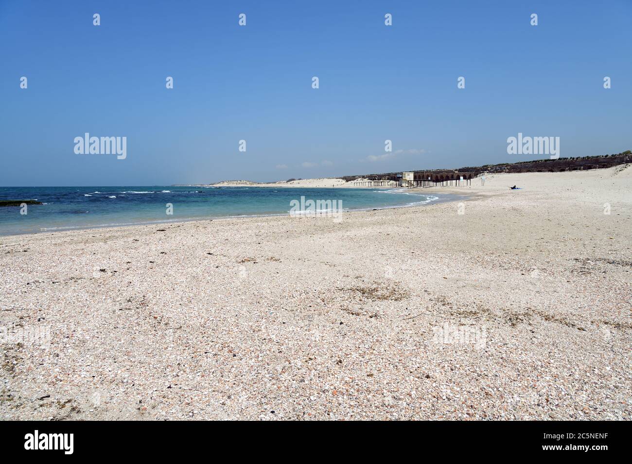 The famous beach nearby ruins of the ancient Roman Aqueduct in city of ...