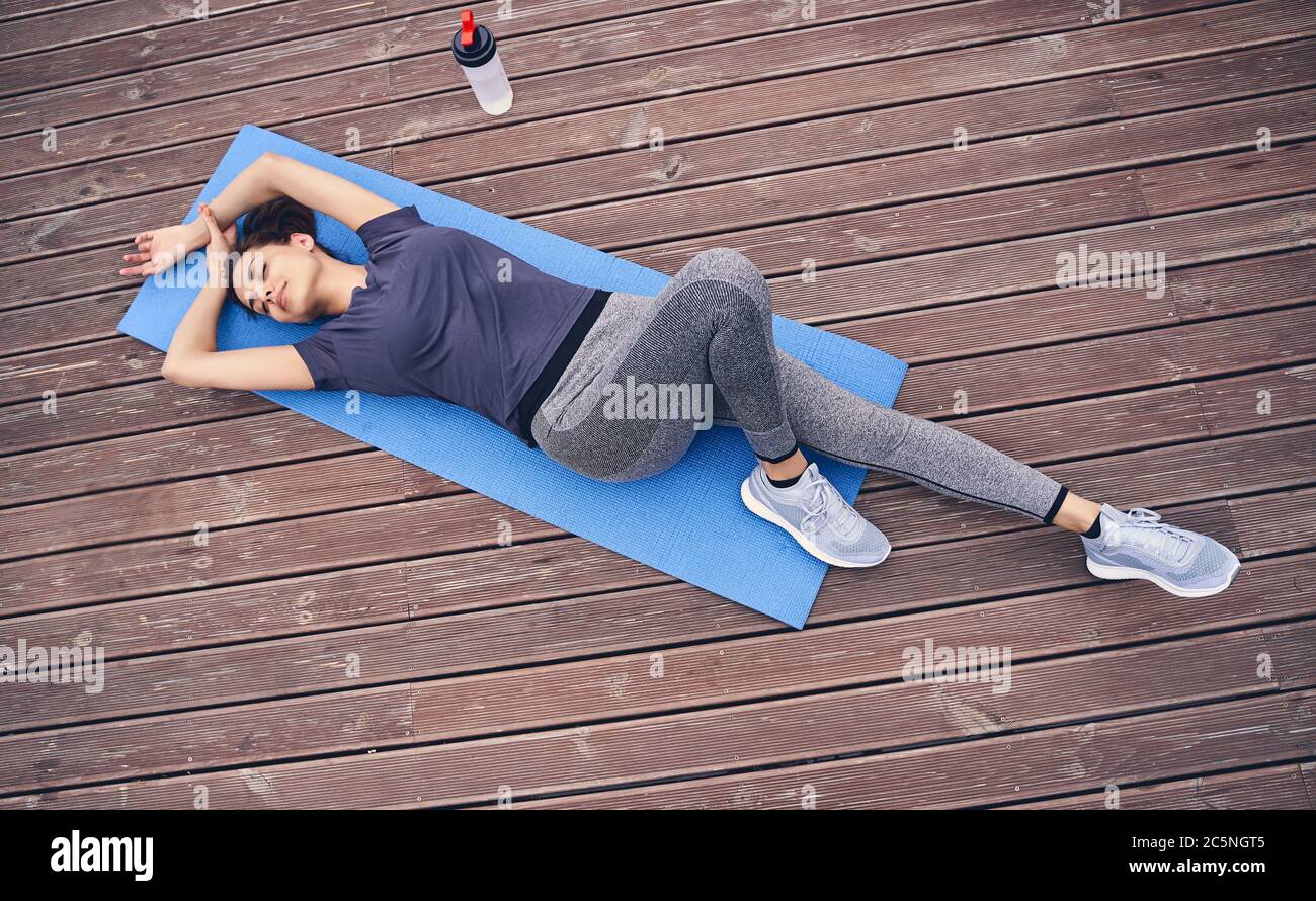 Beautiful young woman resting after morning workout Stock Photo - Alamy