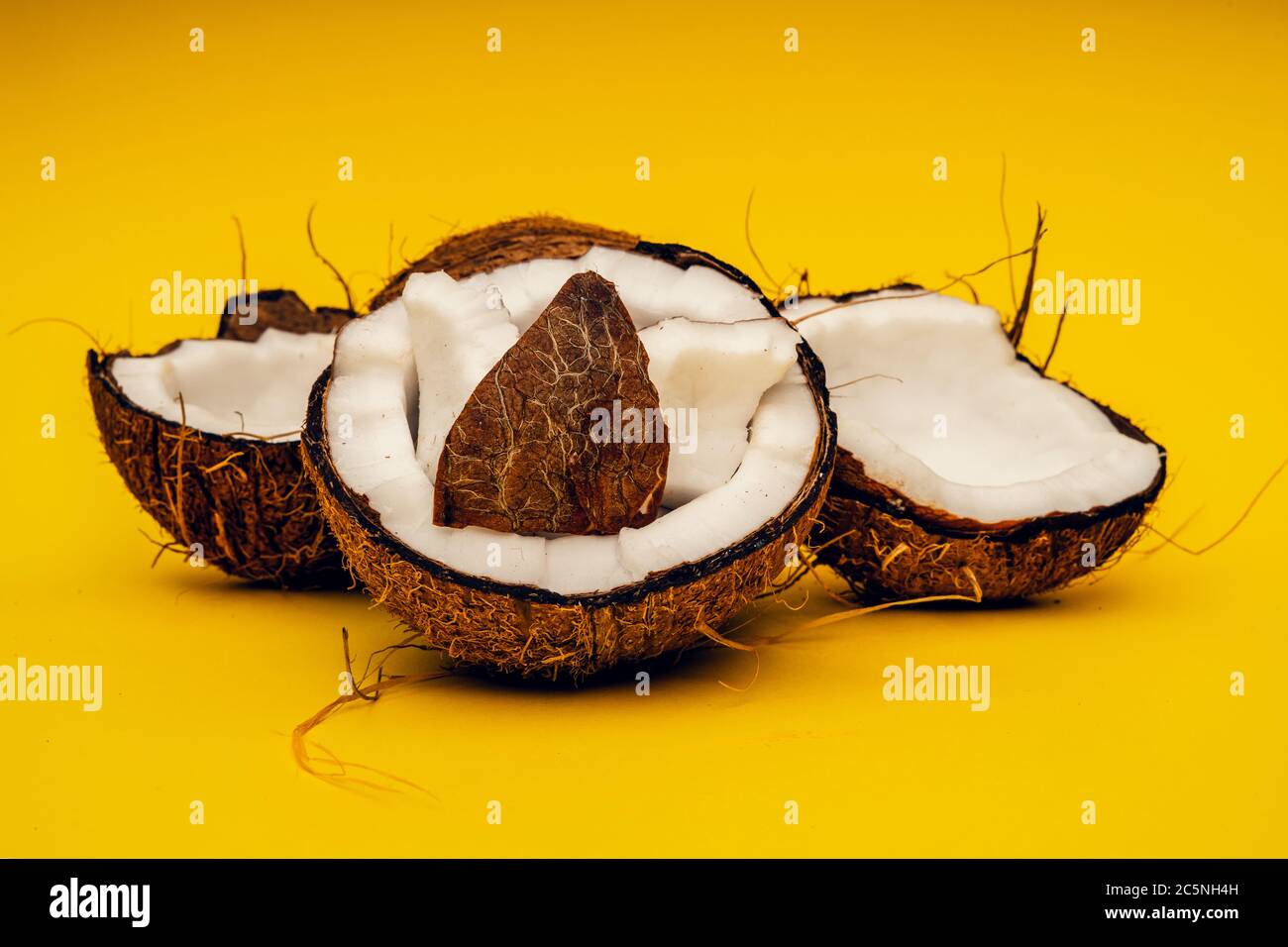 Parts of coconut on a colored background. Close up. Fresh ripe coconut ...