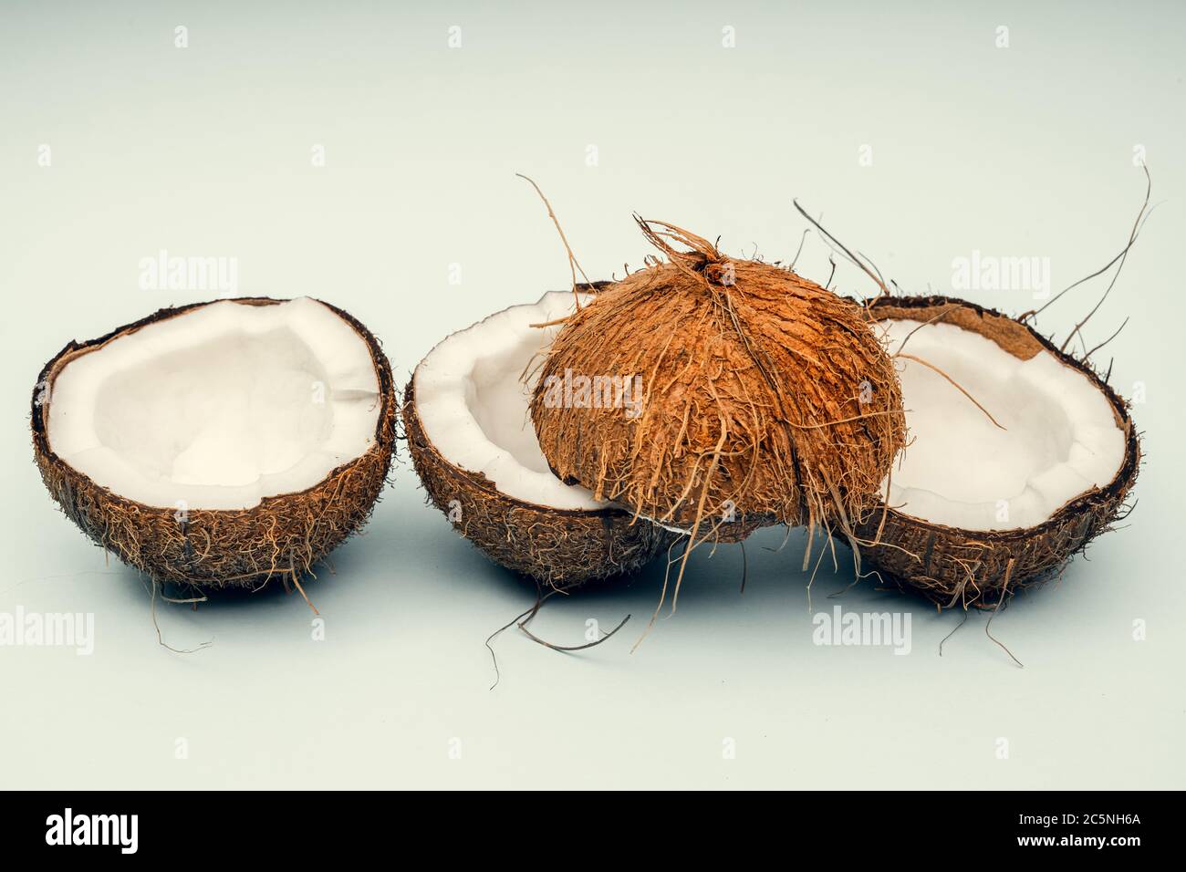 Parts of coconut on a colored background. Close up. Fresh ripe coconut ...