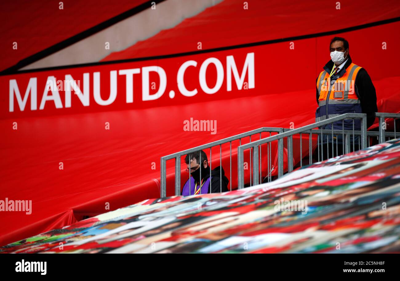 A steward wearing a PPE mask in the stands prior to the Premier League ...