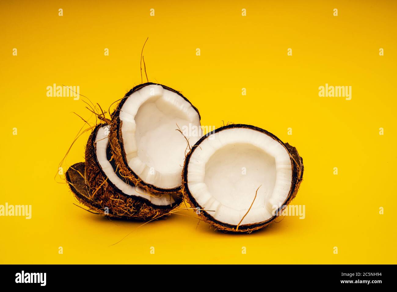 Parts of coconut on a colored background. Close up. Fresh ripe coconut ...