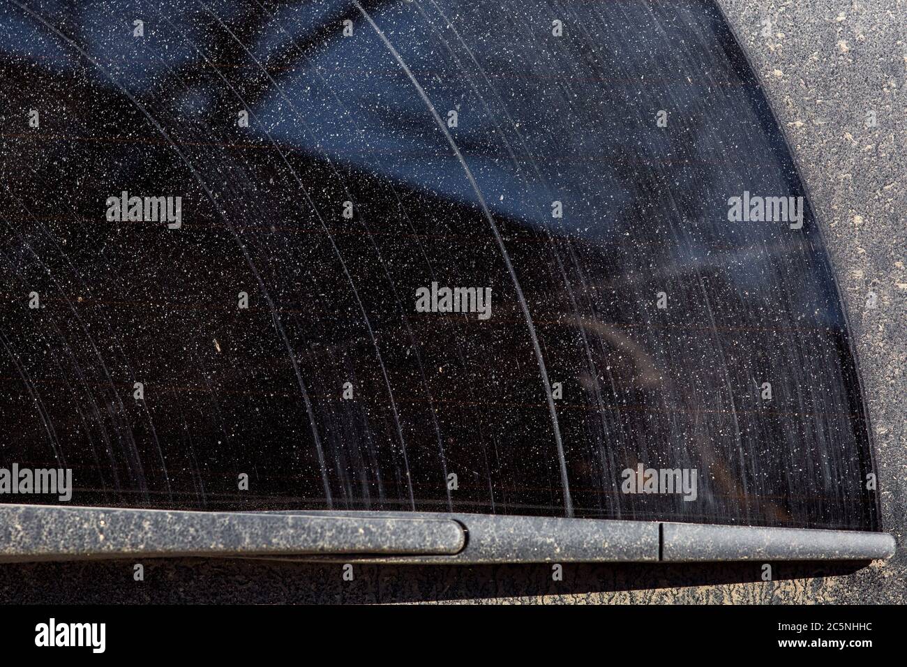 windshield surface with a dirty car wiper, close up of a dirty window ...