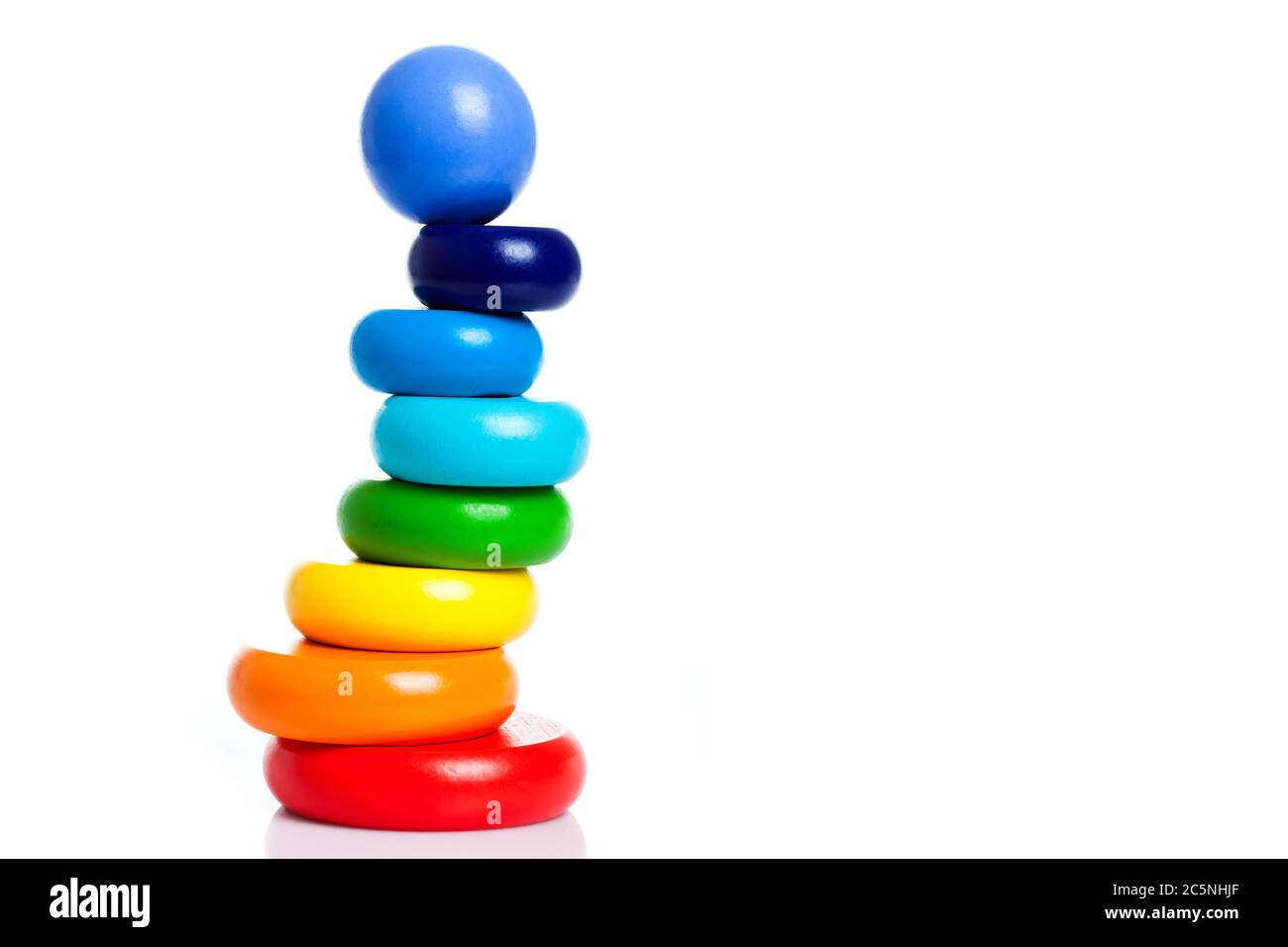 child pyramid of round shape from wooden parts of different colors ...
