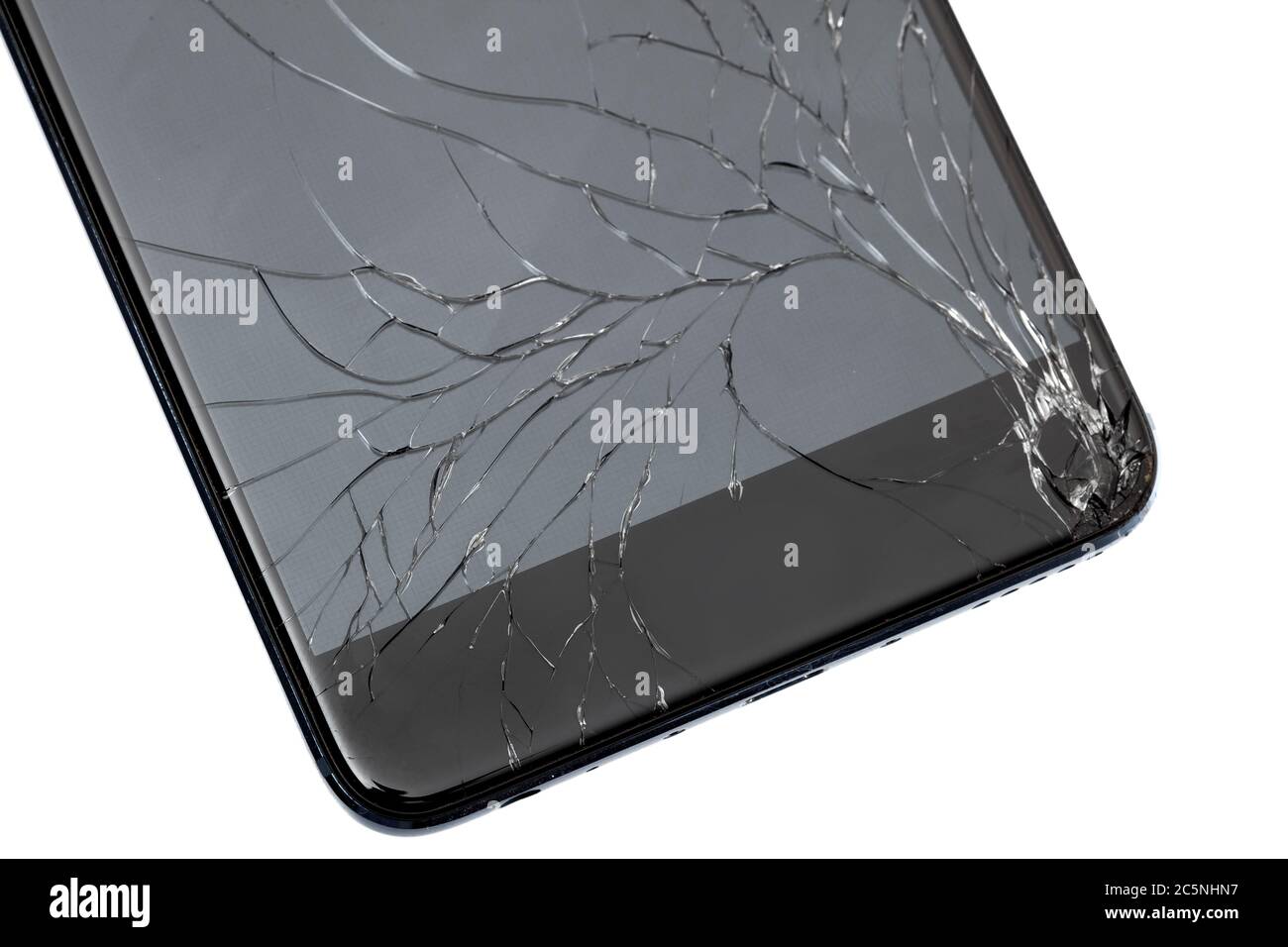 The bottom of the smartphone with a broken glass screen close-up on a ...