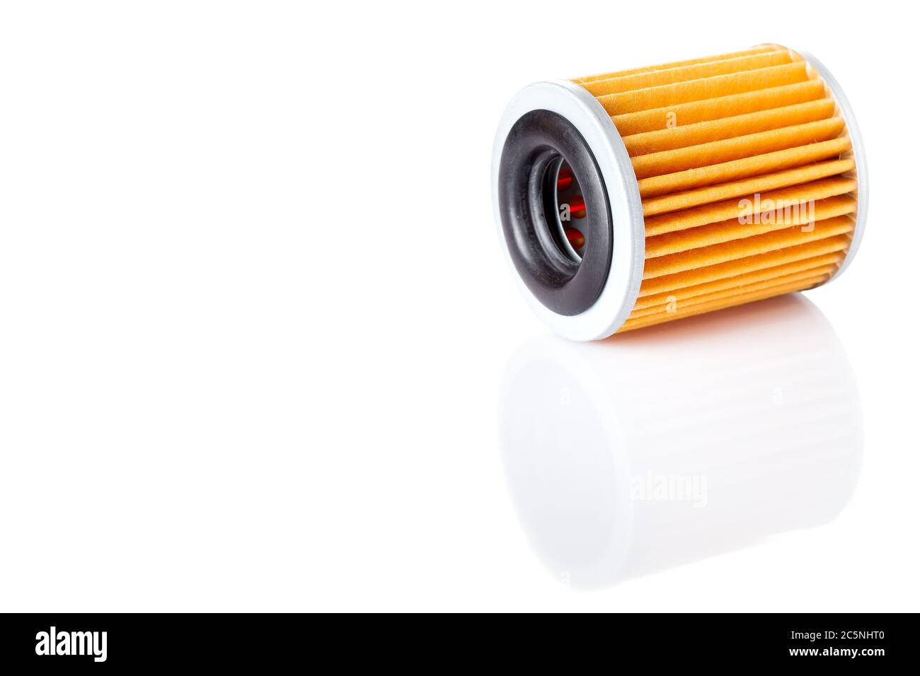 yellow paper car filter lies on its side on a white background with ...