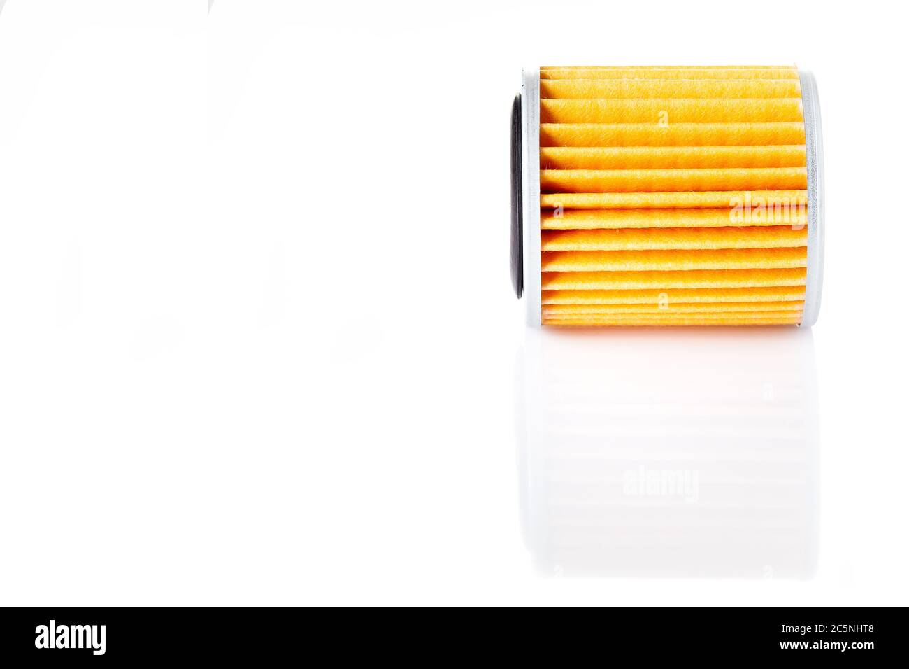 yellow paper car filter lies on its side on a white background with ...