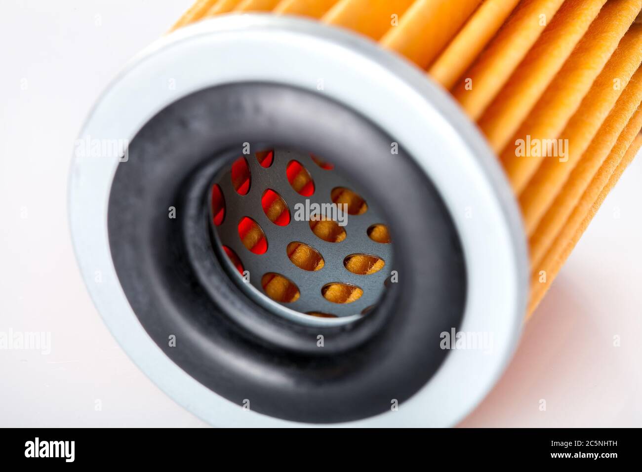 Close-up of an orange-colored paper filter with a metal frame and ...