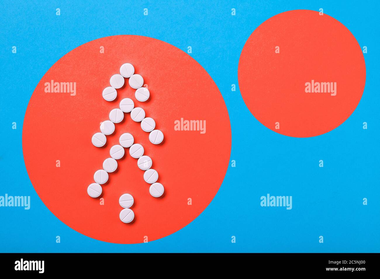 Tree of pills on a blue background and and coral circles as a place for ...