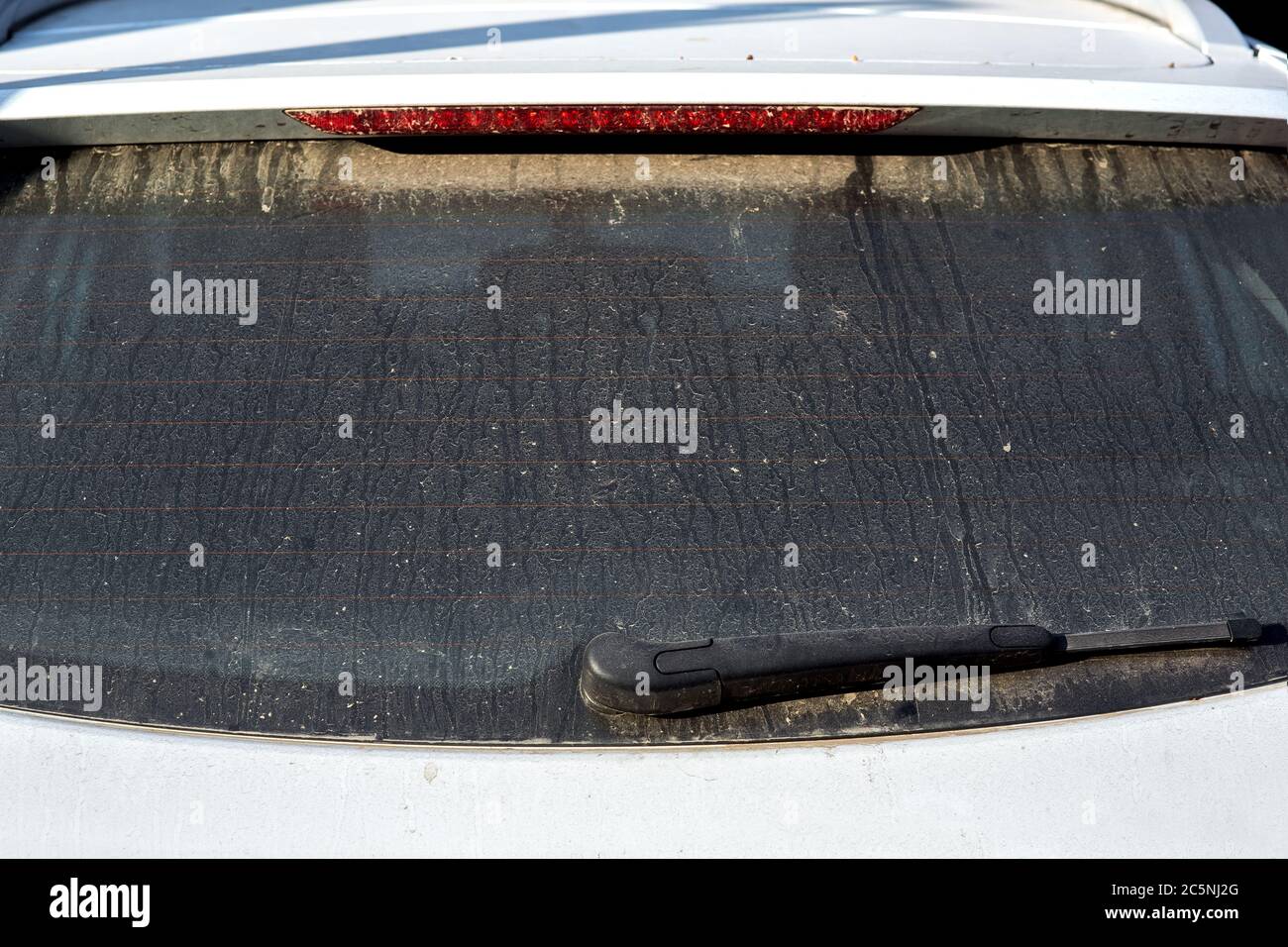 White Dirty car window in dust, station wagon with heated window and ...