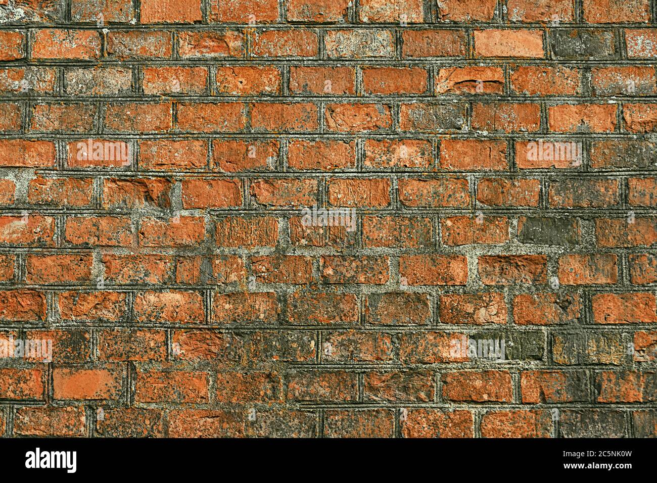 The wall is made of old orange bricks, the masonry is uneven Stock ...