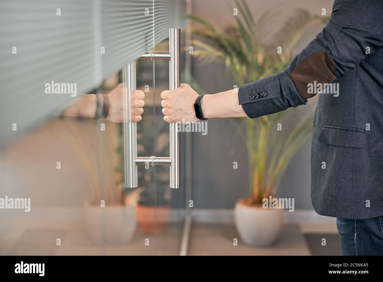 Man hand open the door with glass reflection background Stock Photo - Alamy