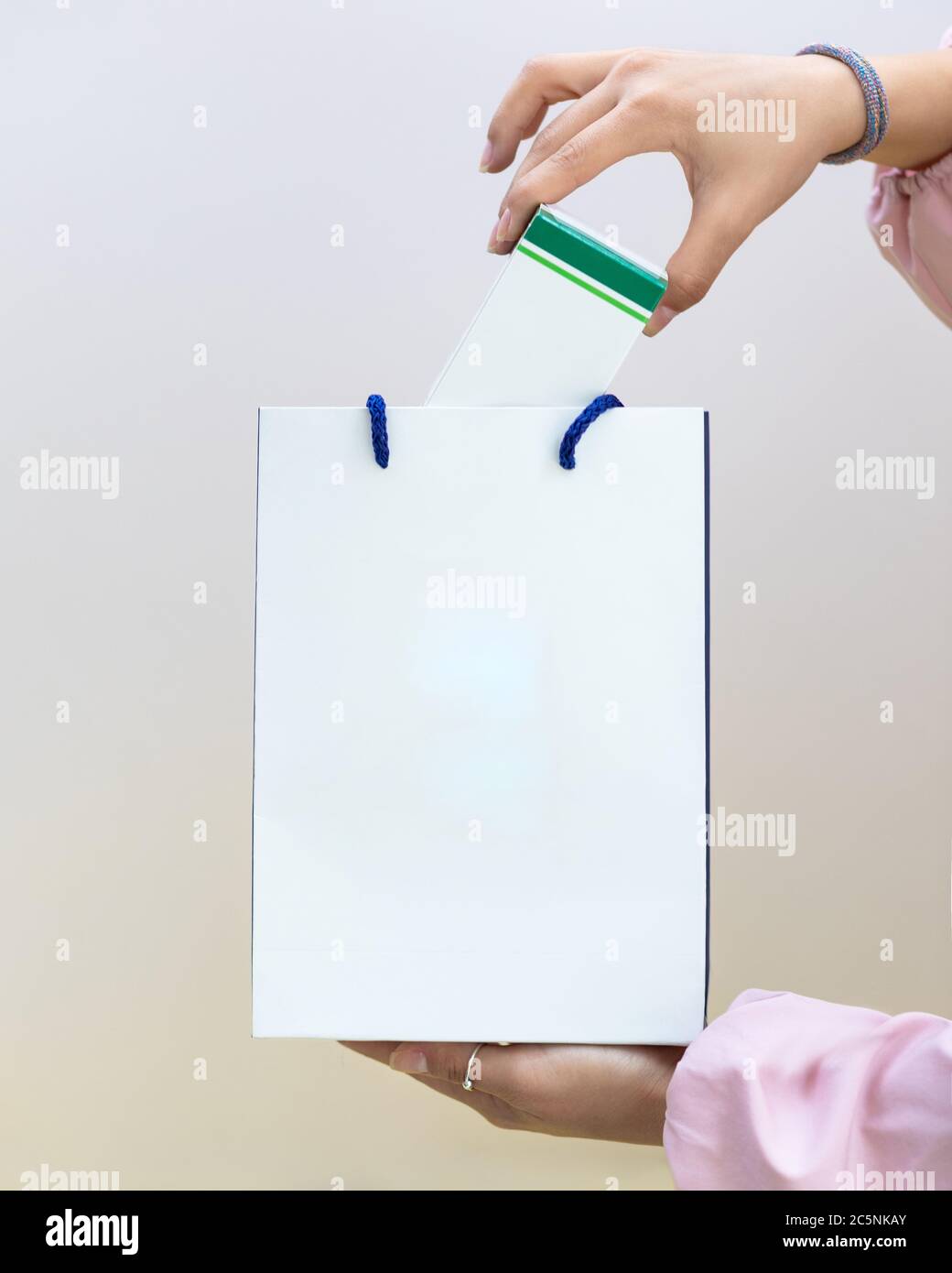 Girl putting into bag hi-res stock photography and images - Alamy