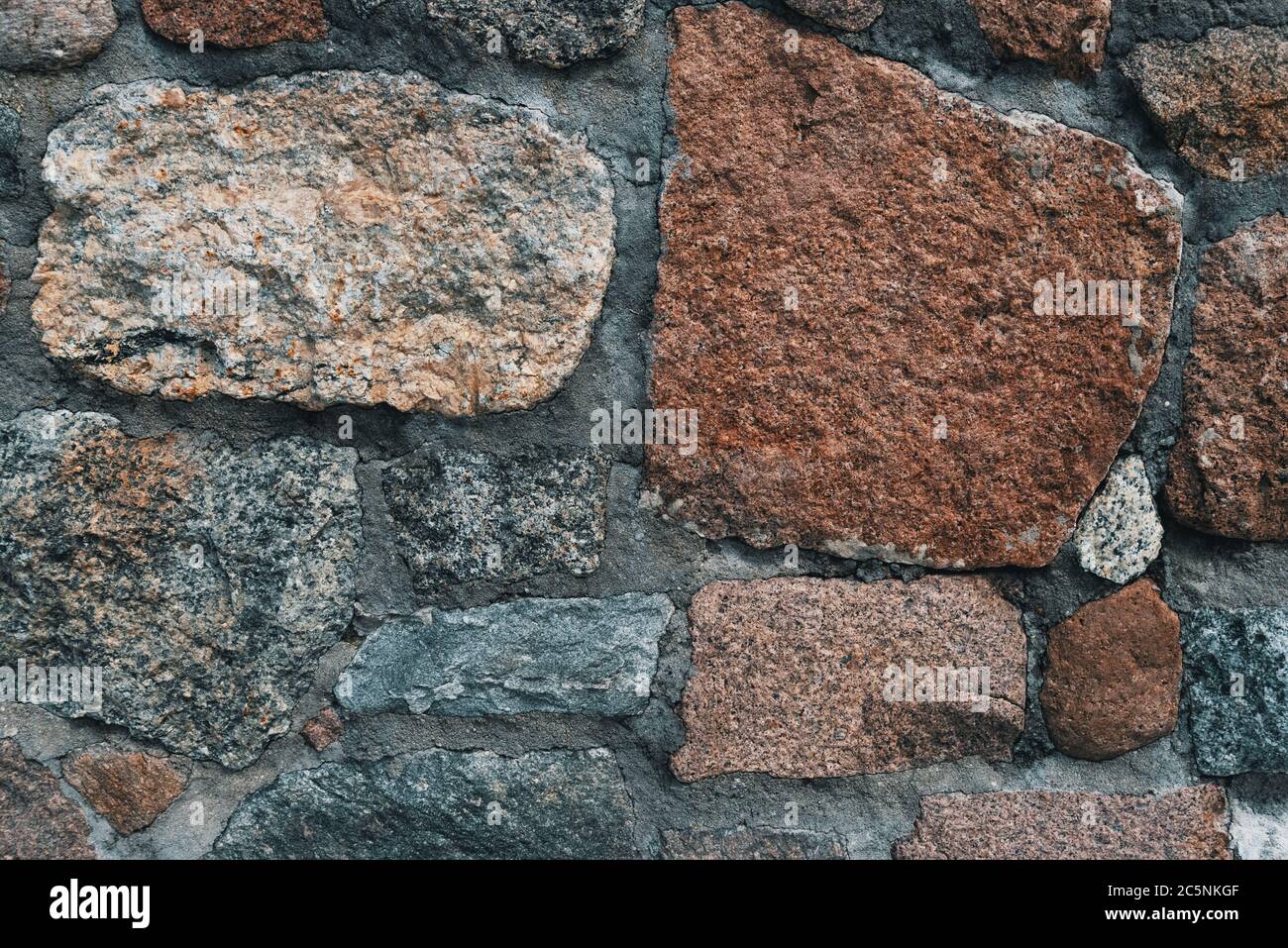 Background of old stone wall with stones of different sizes and colors ...
