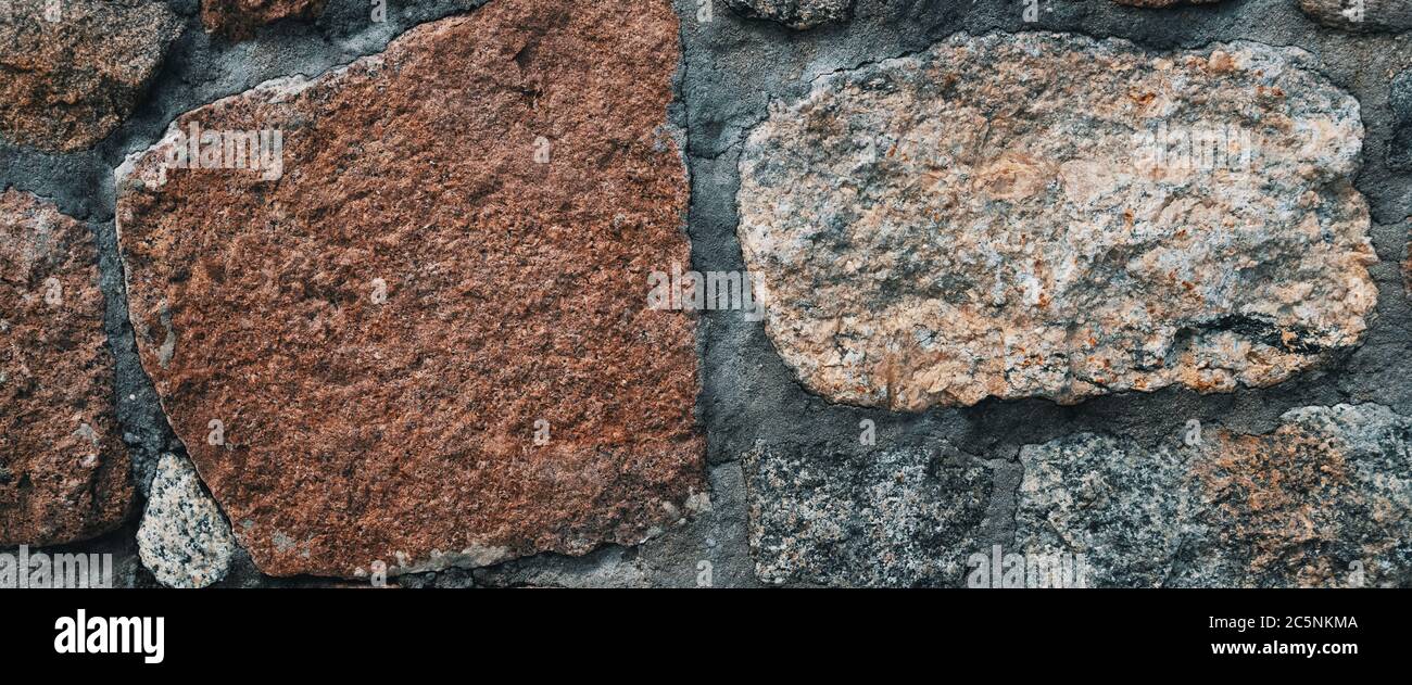Background of old stone wall with stones of different sizes and colors ...