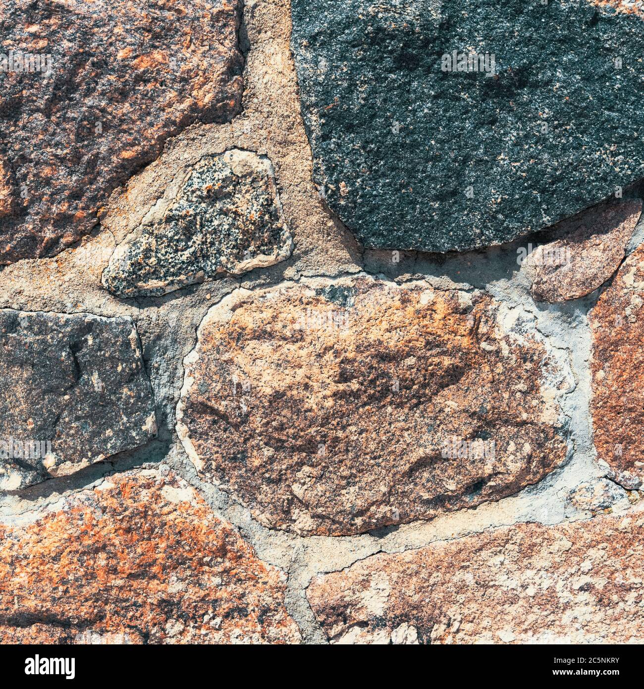 Background of old stone wall with stones of different sizes and colors ...