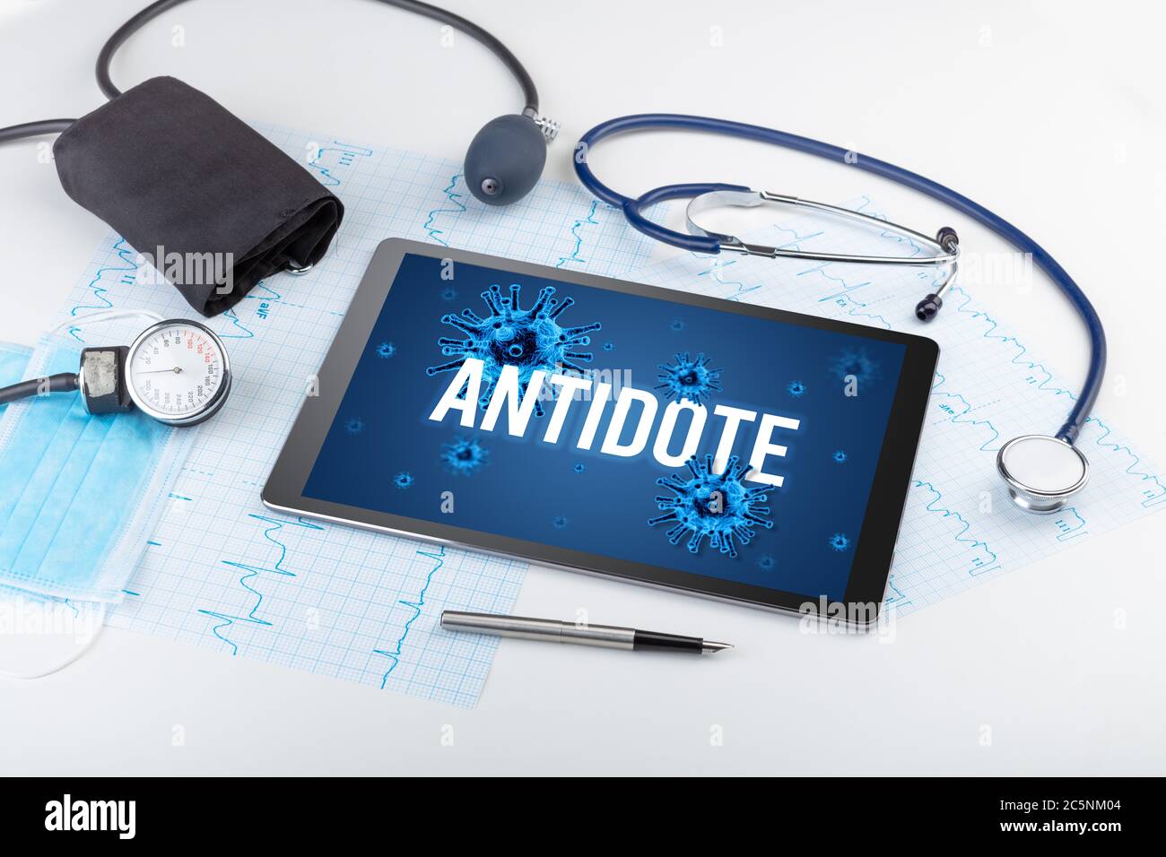 Tablet pc and doctor tools on white surface with ANTIDOTE inscription ...