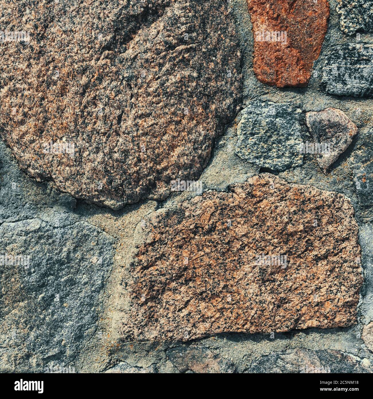 Background of old stone wall with stones of different sizes and colors ...