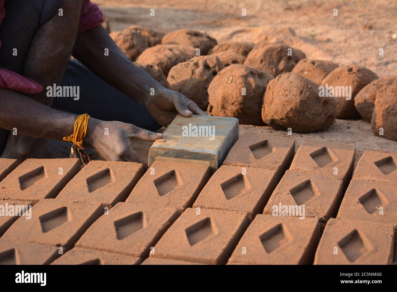 Hands of worker making bricks with clay and mud Stock Photo - Alamy