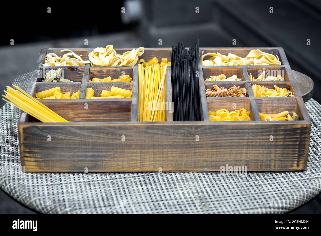 wooden box with cells for different types of pasta from traditional ...