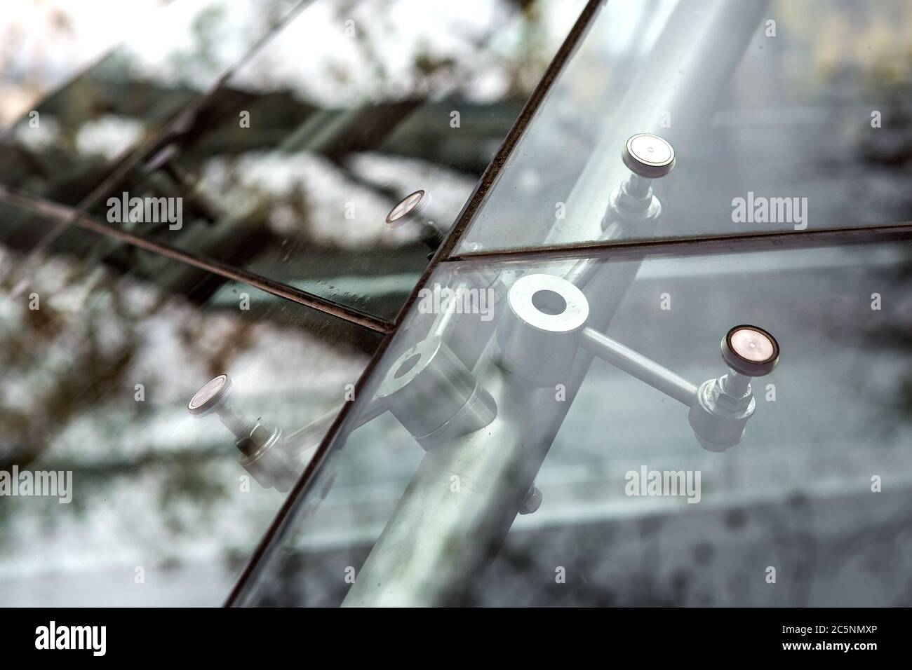 The design of glass facades is a closeup of chrome-plated fasteners ...