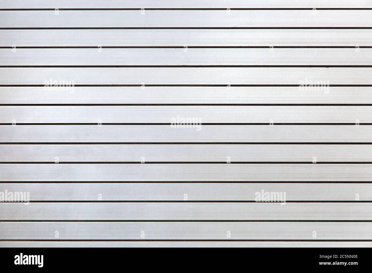 horizontal iron roller shutters of gray color close-up, metal gate ...