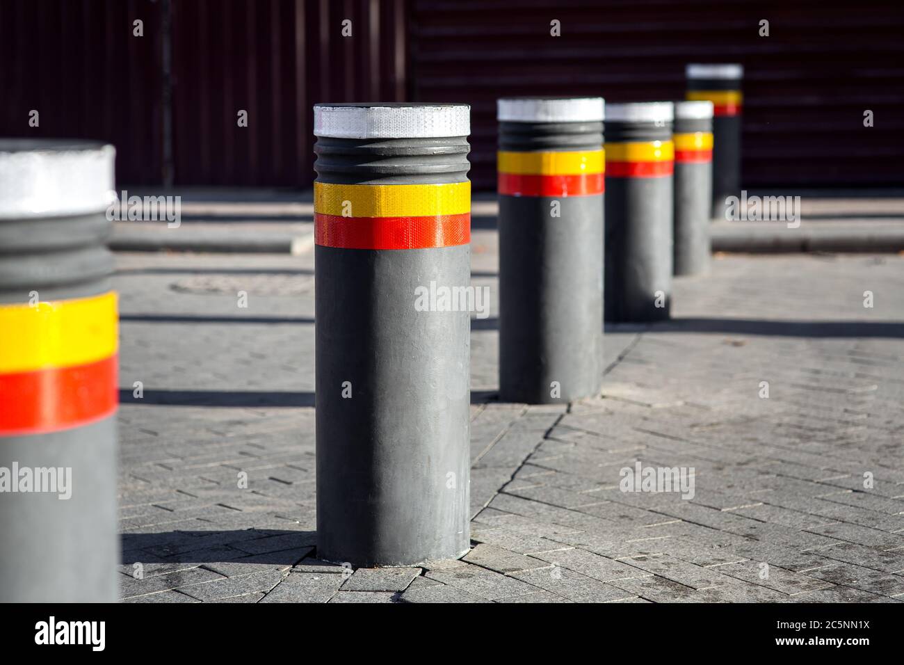 bollards with reflective stripes enclose the passage of transport to ...