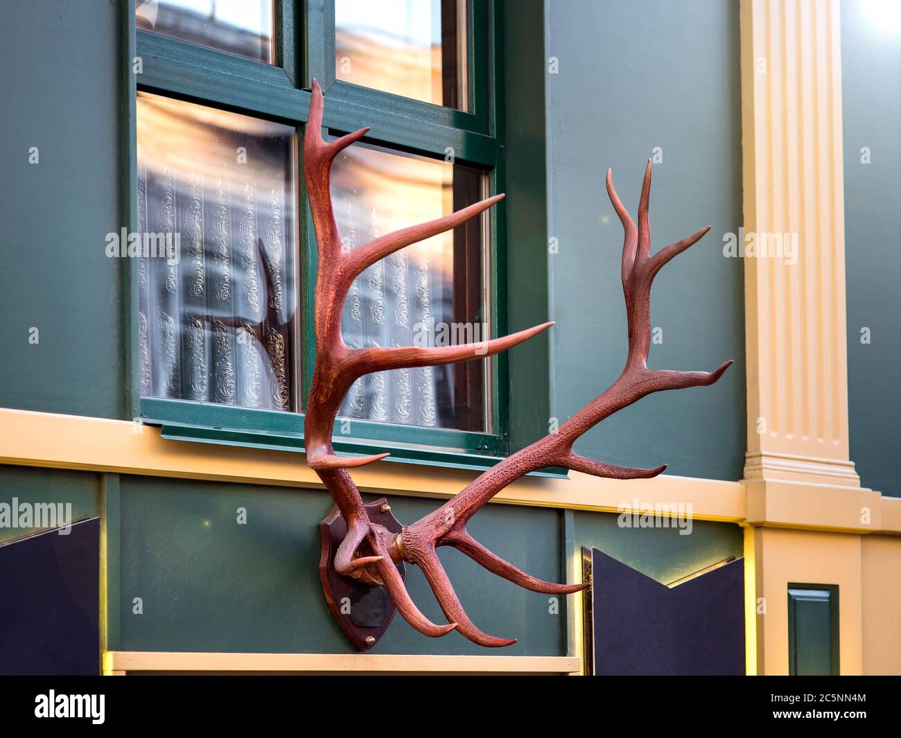 Antlers on the facade of the building at the entrance to a traditional ...
