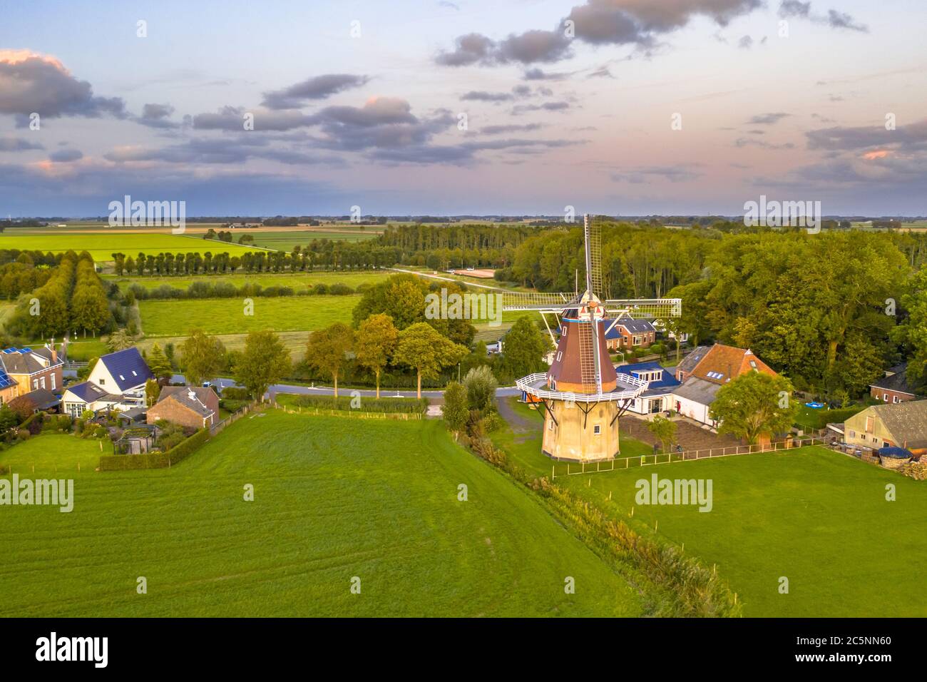 Aerial view of sunset over dutch village in agricultural countryside ...