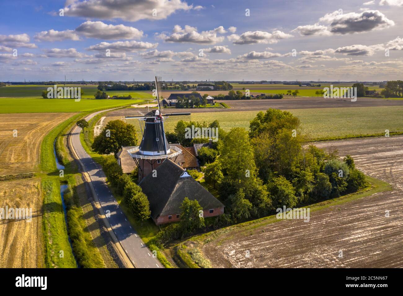 Aerial view of small dutch hamlet with historic wooden windmill in ...