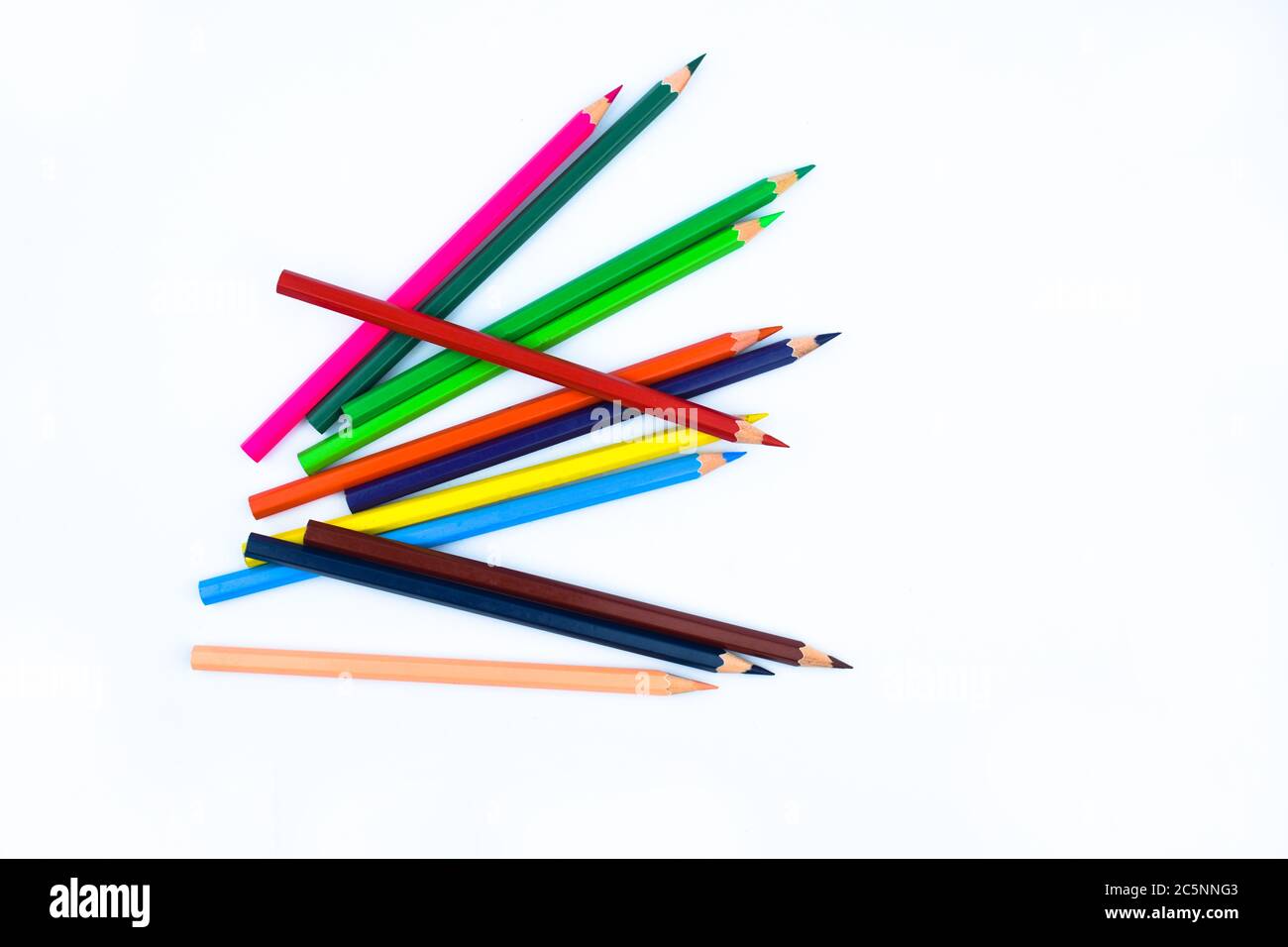 A stack of different colored wood pencil crayons placed on an empty ...