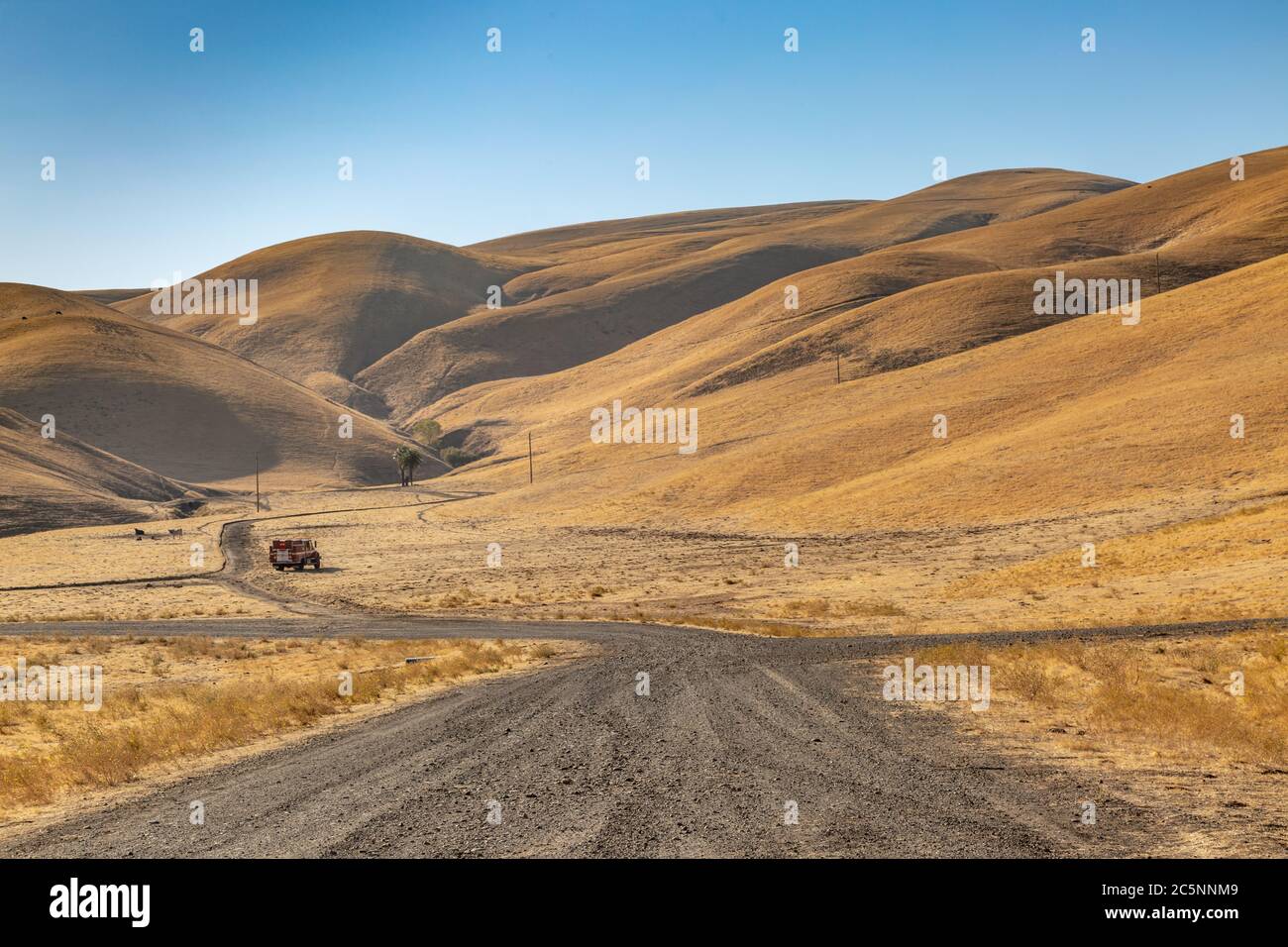 A firetruck in the parched Californian countryside, with a clear sky ...