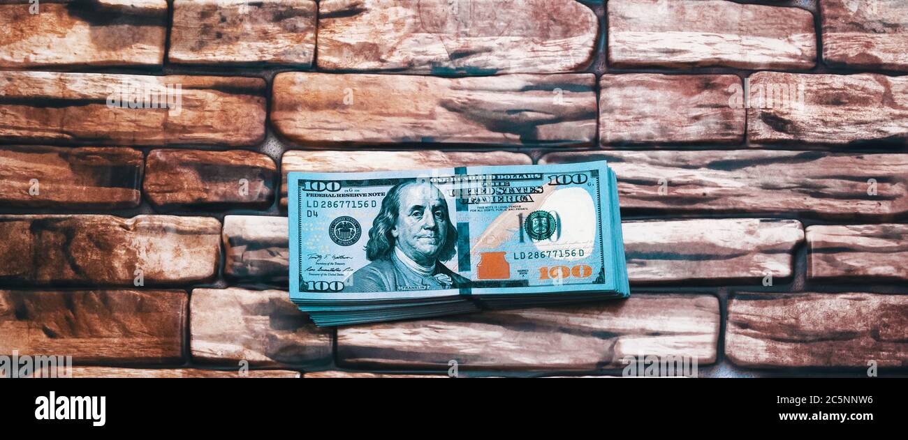 A pack of dollars.A large wad of hundred-dollar bills is lying on a ...